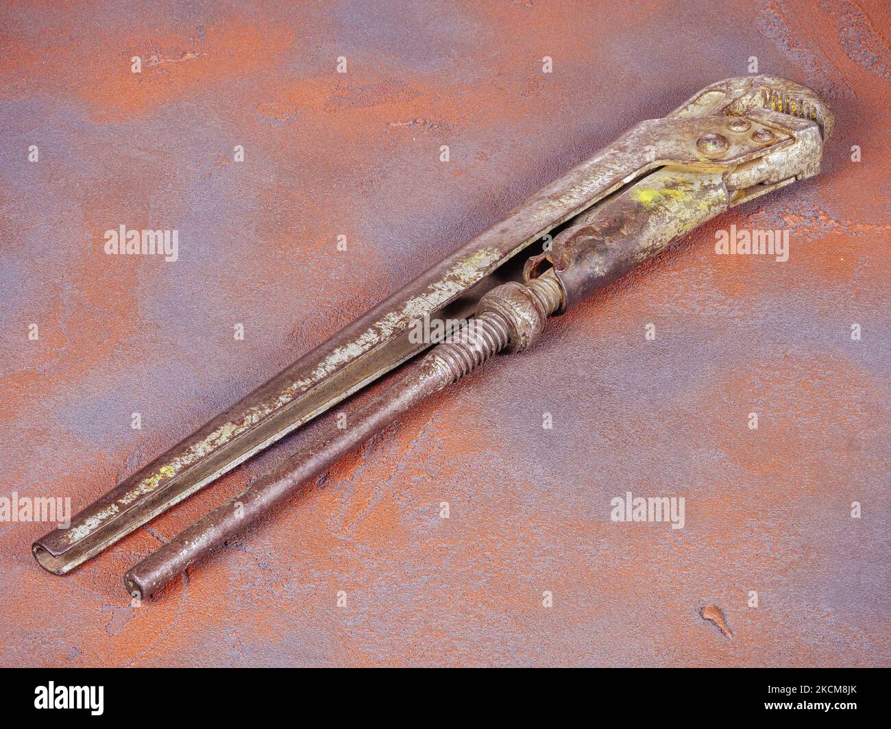 Old rusty adjustable spanner on a grunge orange background Stock Photo ...