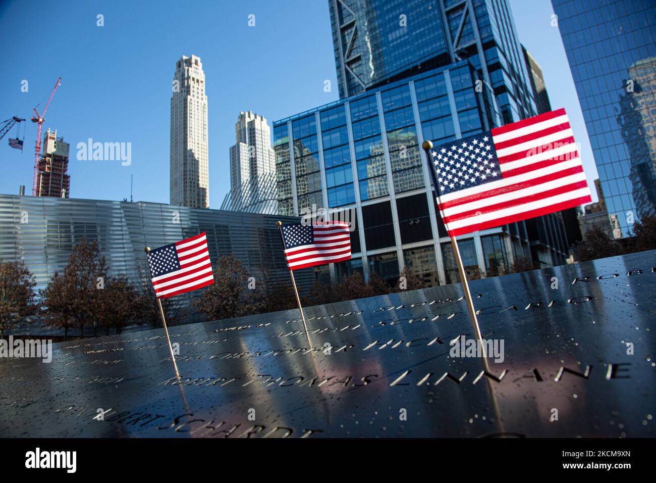 US flags on the inscription of the names of the victims with flowers on ...