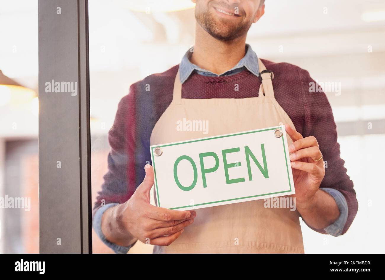 Ready to serve you. Portrait of a young business owner standing in the ...