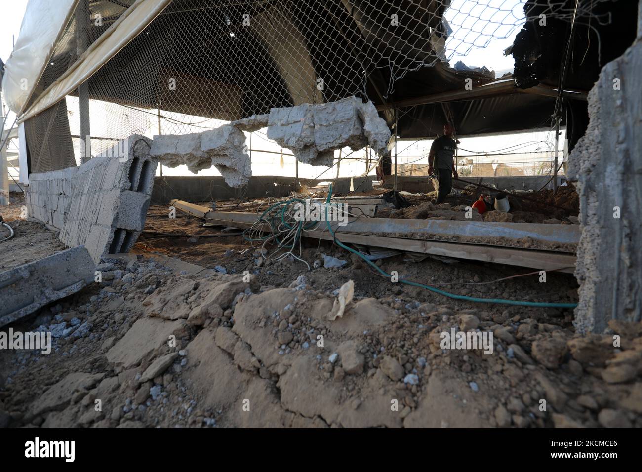 A Palestinian man inspects the damage following reported Israeli ...