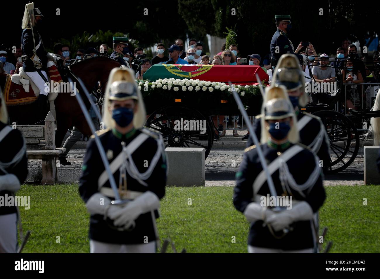 A horse-drawn carriage carrying the coffin of the late former ...