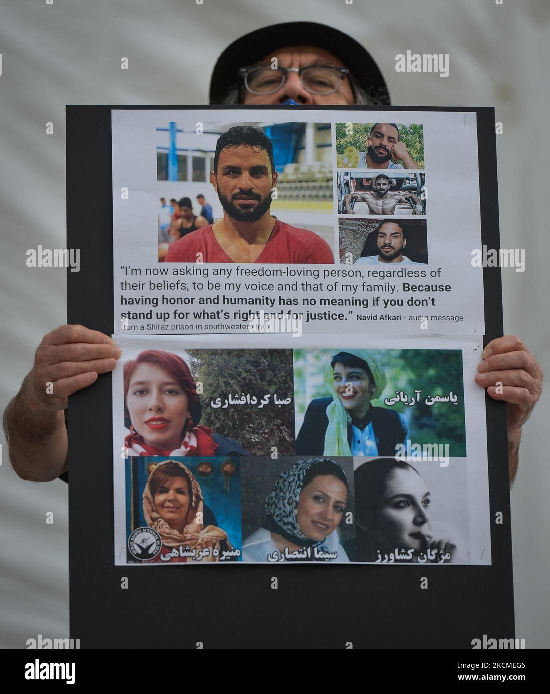 A protester holds posters with Navid Afkari images. Members of the ...