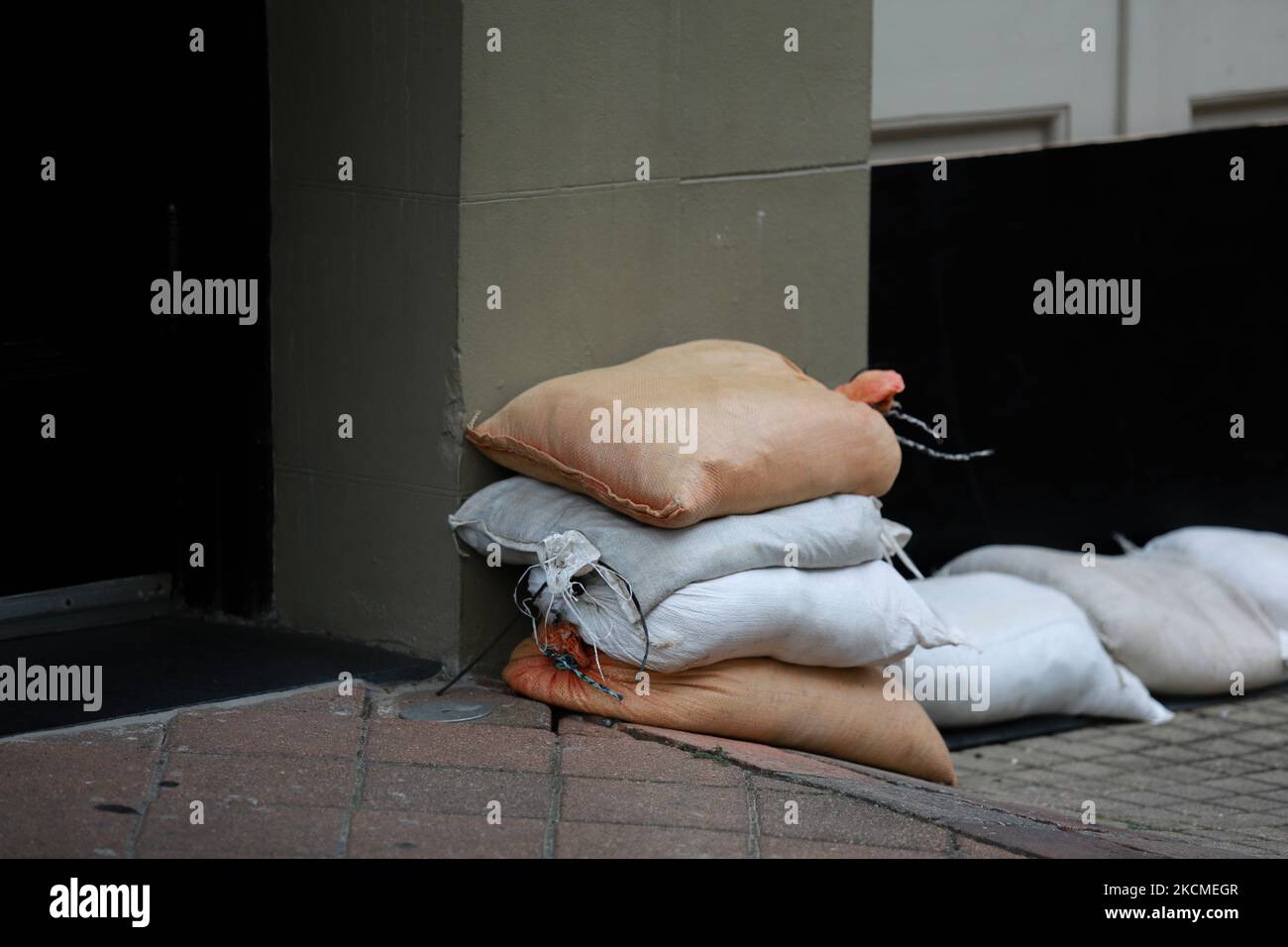 Shop owners line their doors and windows with sand bags and wooden ...