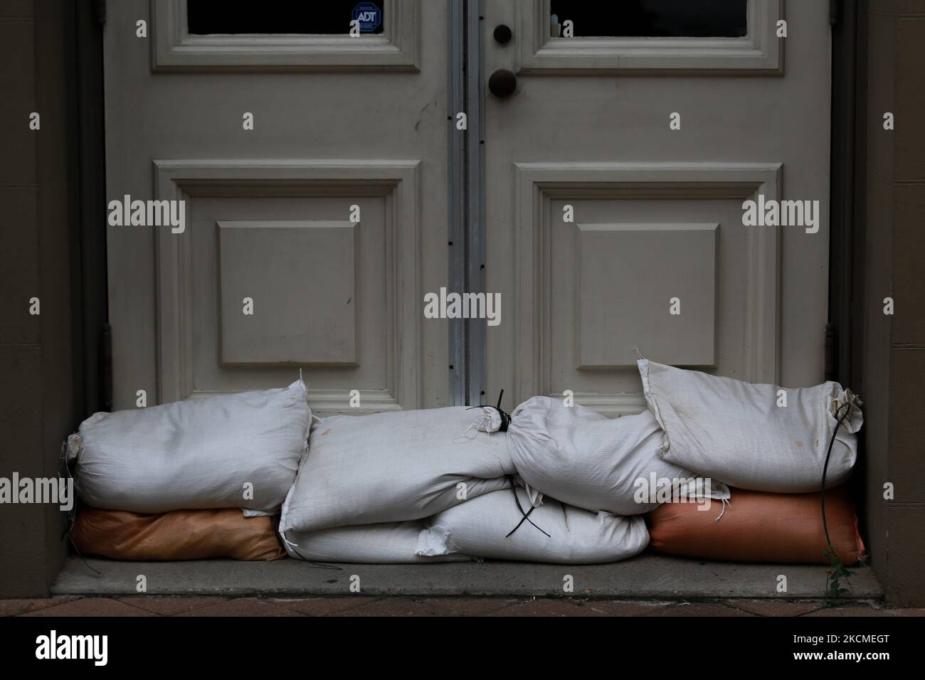 Shop owners line their doors and windows with sand bags and wooden ...