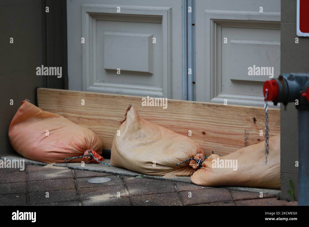 Shop owners line their doors and windows with sand bags and wooden ...