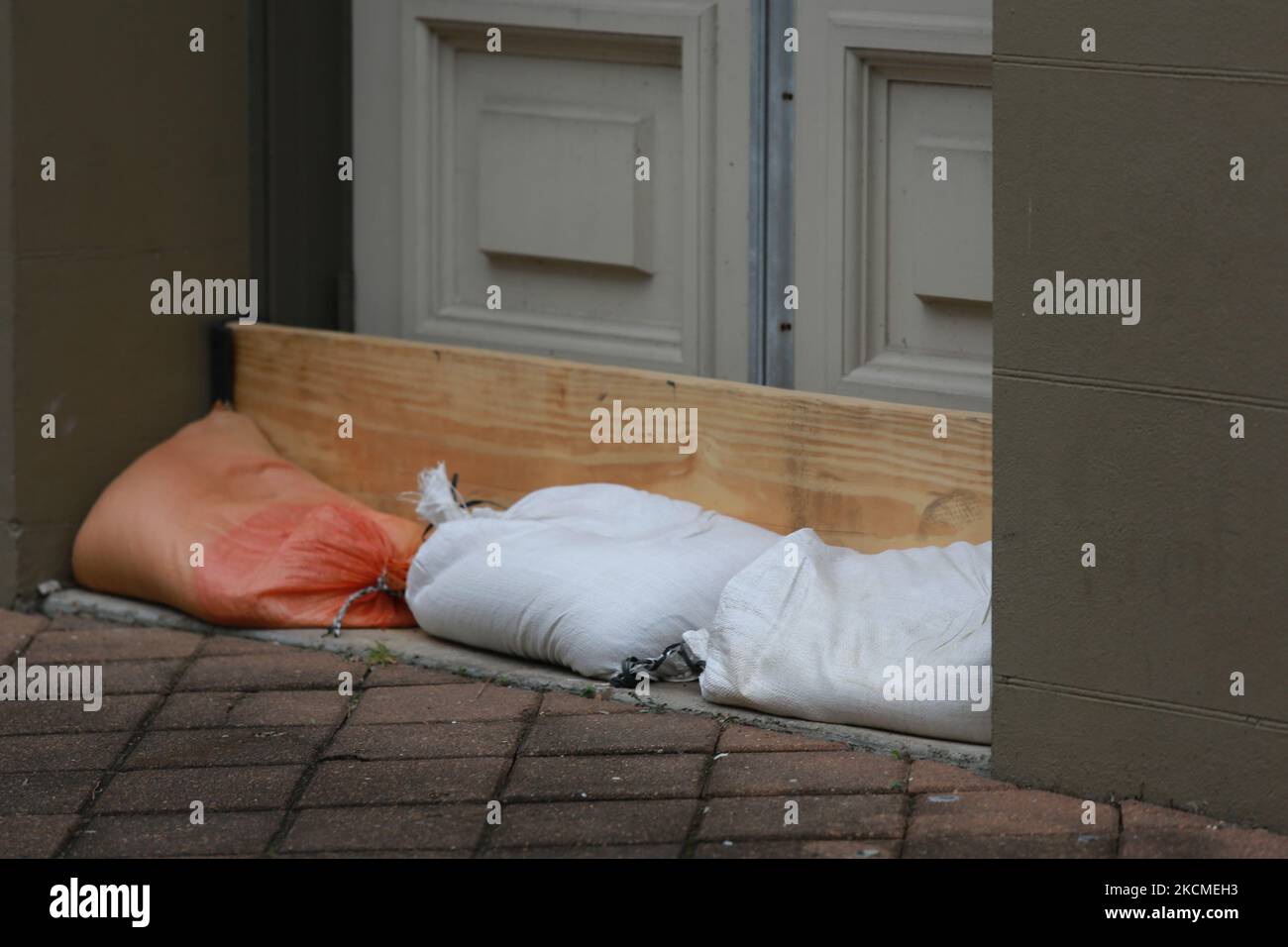 Shop owners line their doors and windows with sand bags and wooden ...