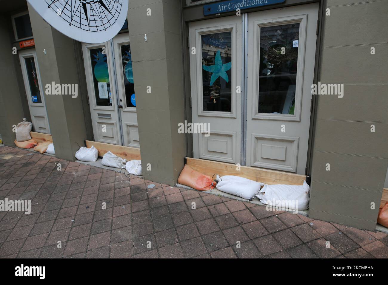Shop owners line their doors and windows with sand bags and wooden ...