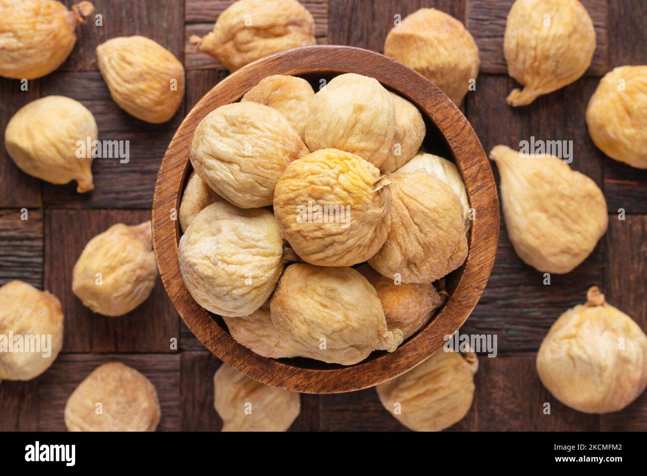 dried figs in bowl on wooden table background Stock Photo - Alamy