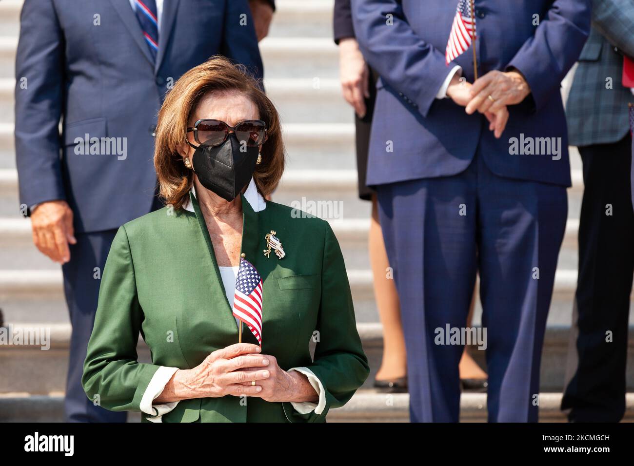 House Speaker Nancy Pelosi (D-CA) holds an American flag during a ...