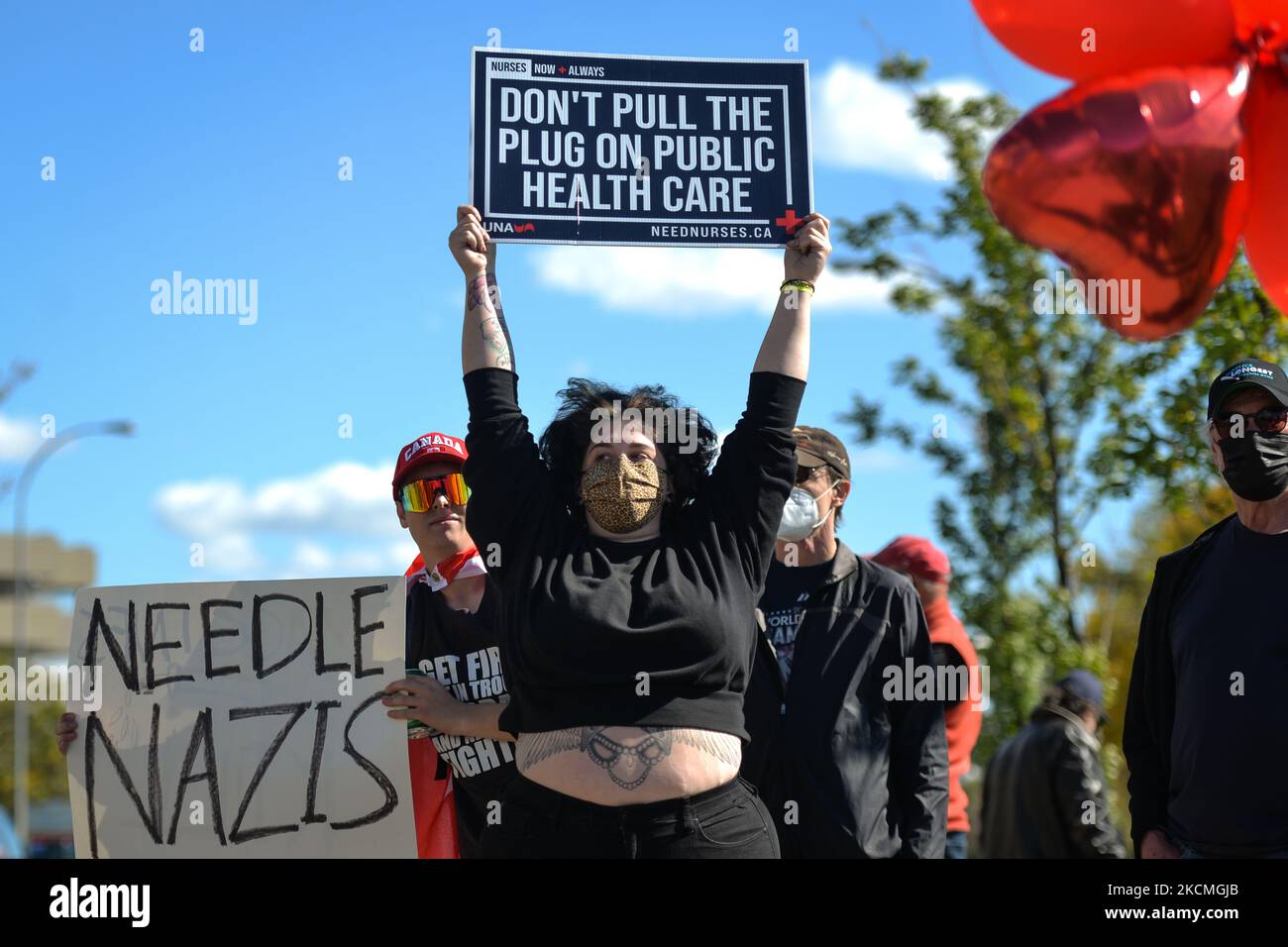 A counter-protester in support of health care workers seen in front of ...
