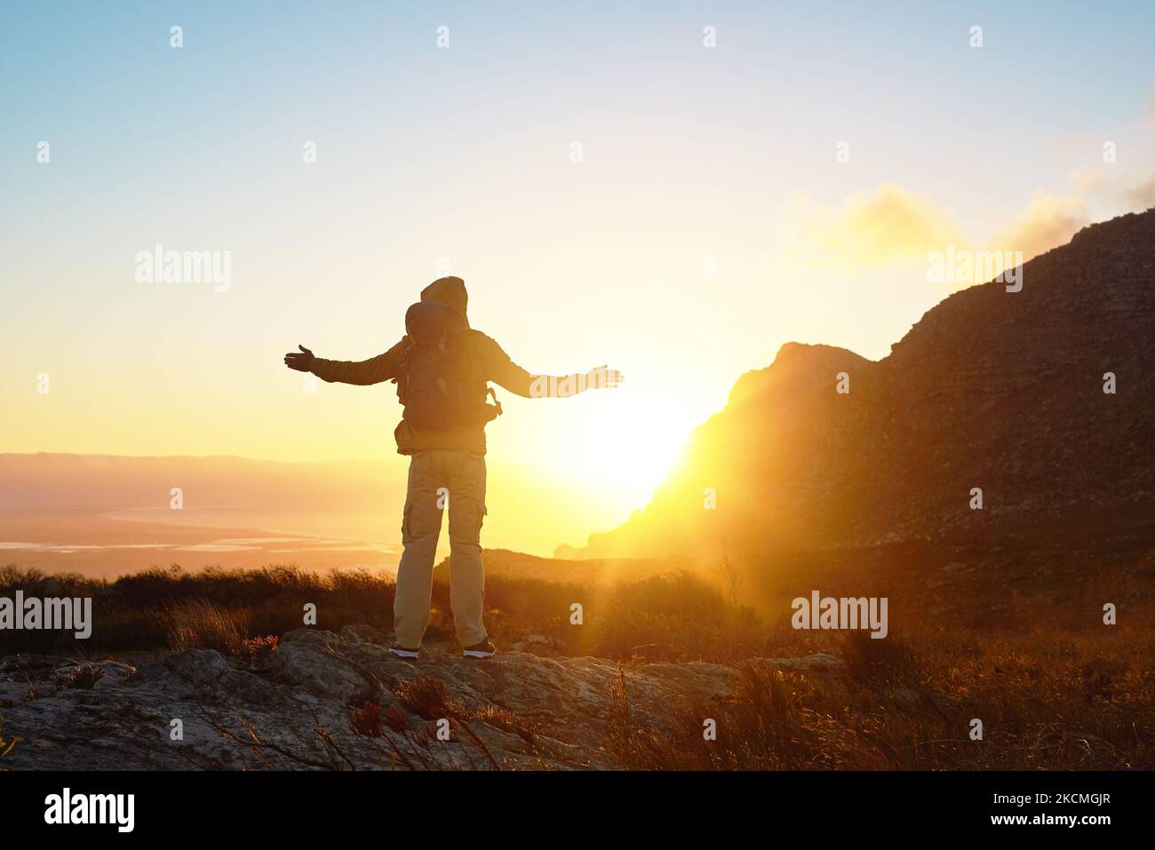 The sun shines upon me with all its blessings. a hiker on top of a ...