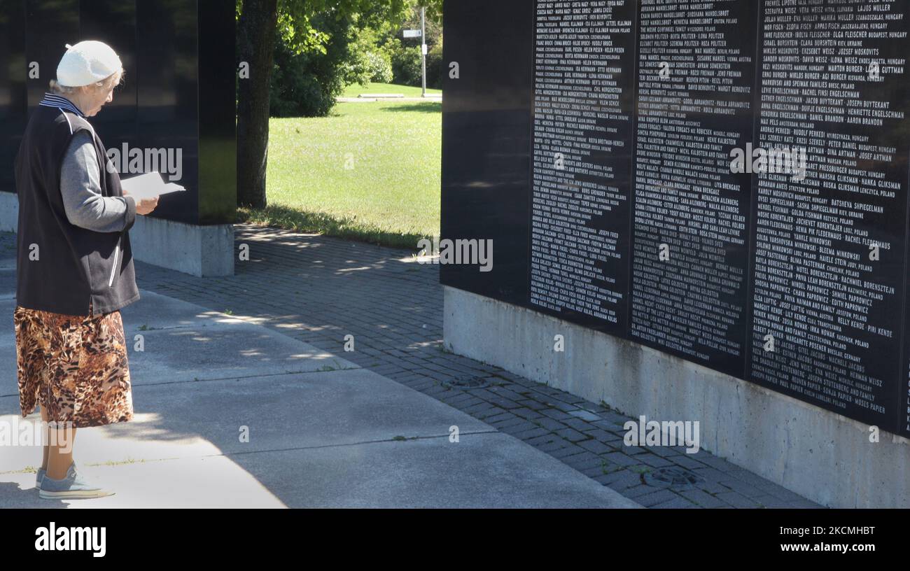 An elderly Jewish woman stands at the Holocaust Memorial in Toronto ...