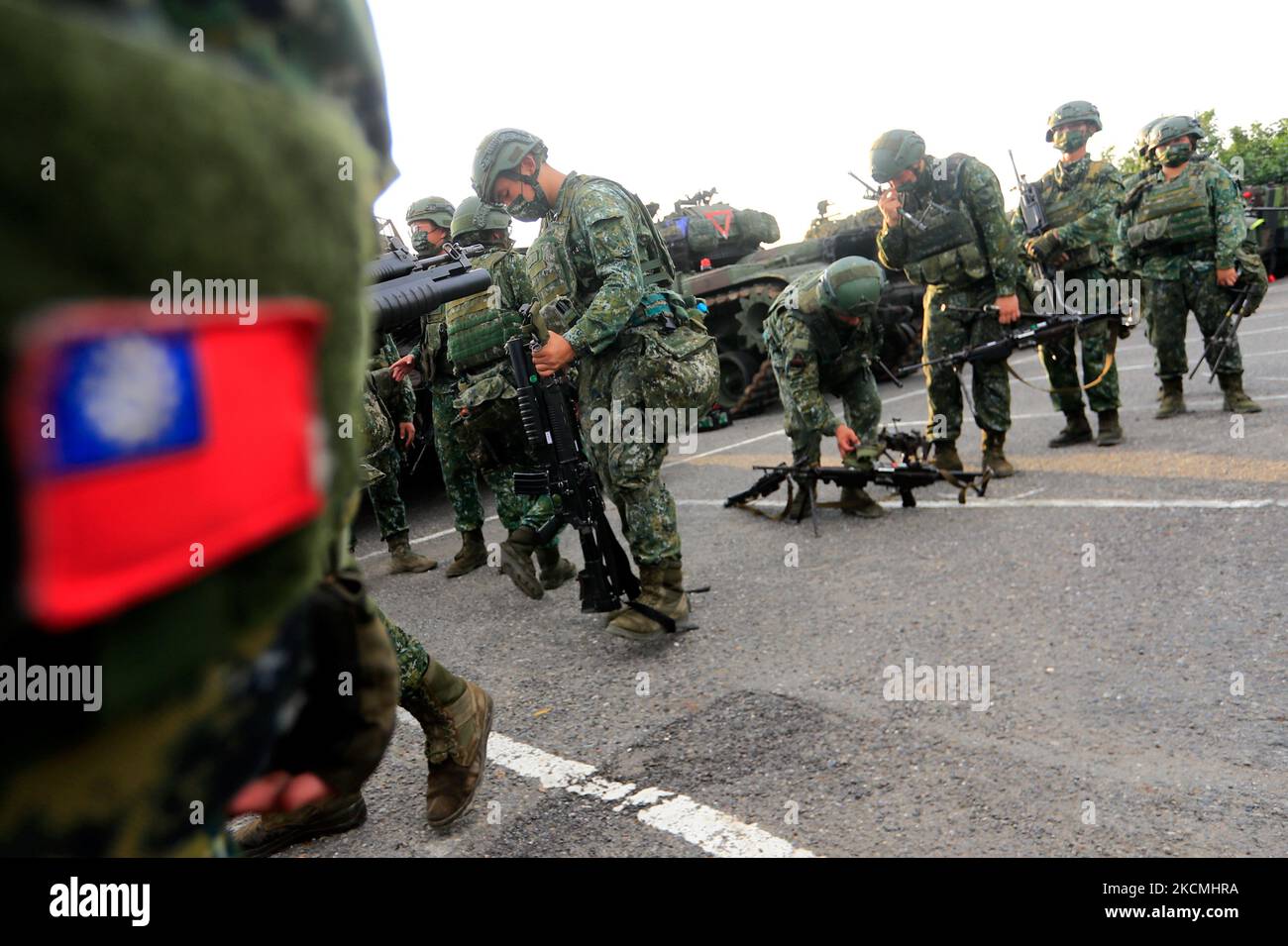 Taiwanese soldiers are seen holding grenade launchers and machine guns ...