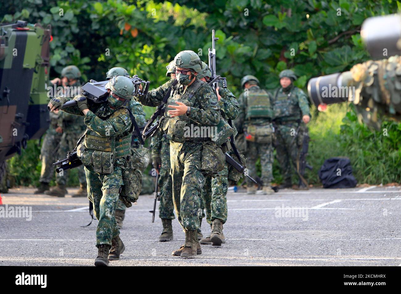 Taiwanese soldiers are seen holding grenade launchers and machine guns ...