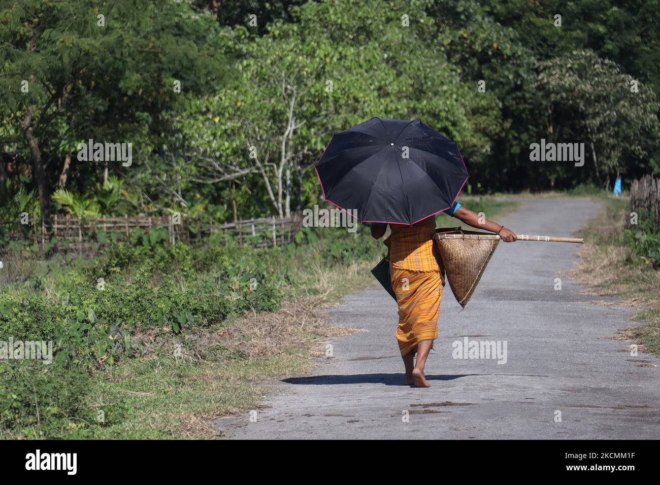 Bodo community women returns holding traditional fishing equipment ...