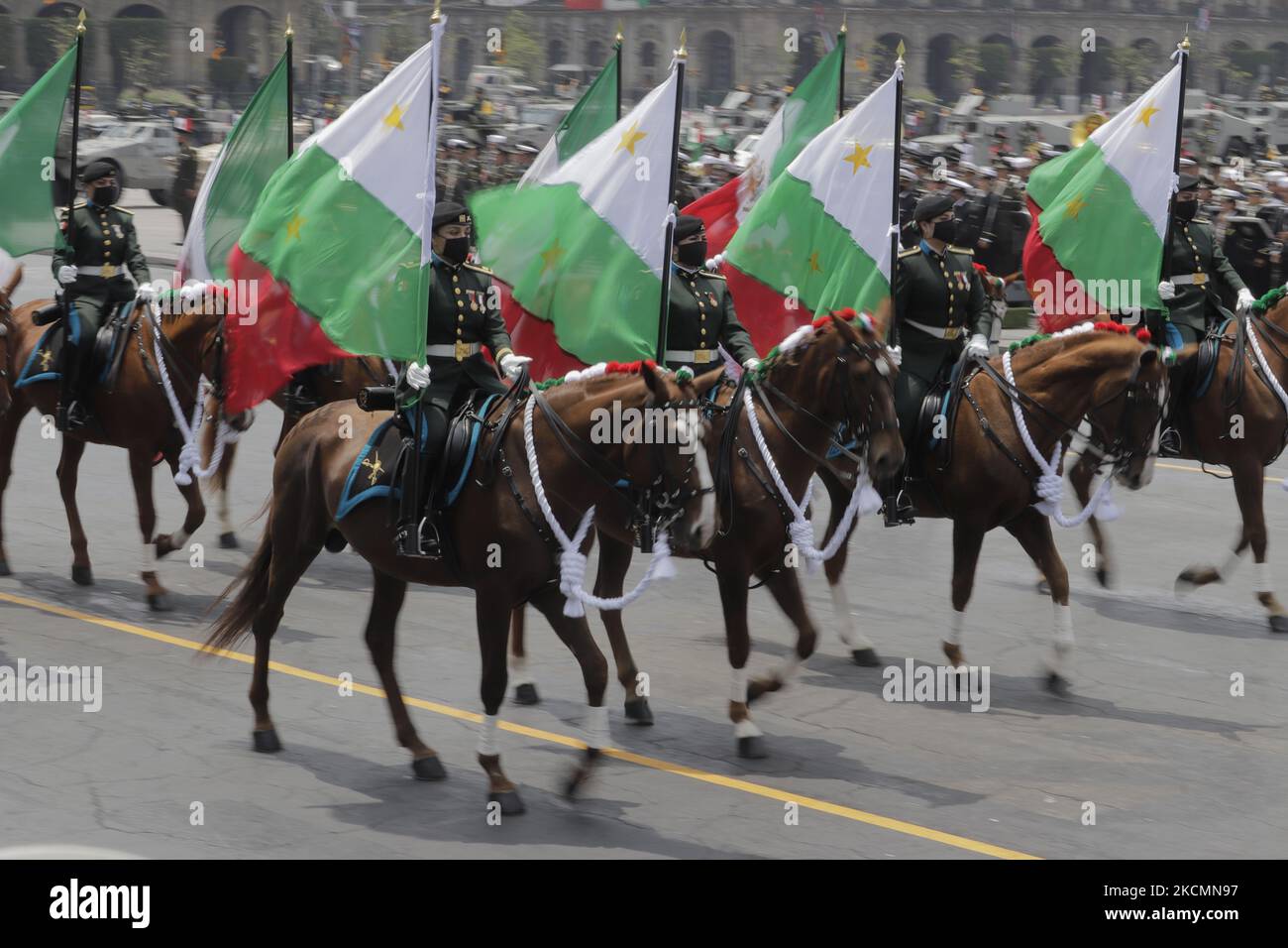 A Mexican army mounted brigade carries flags during the military parade ...