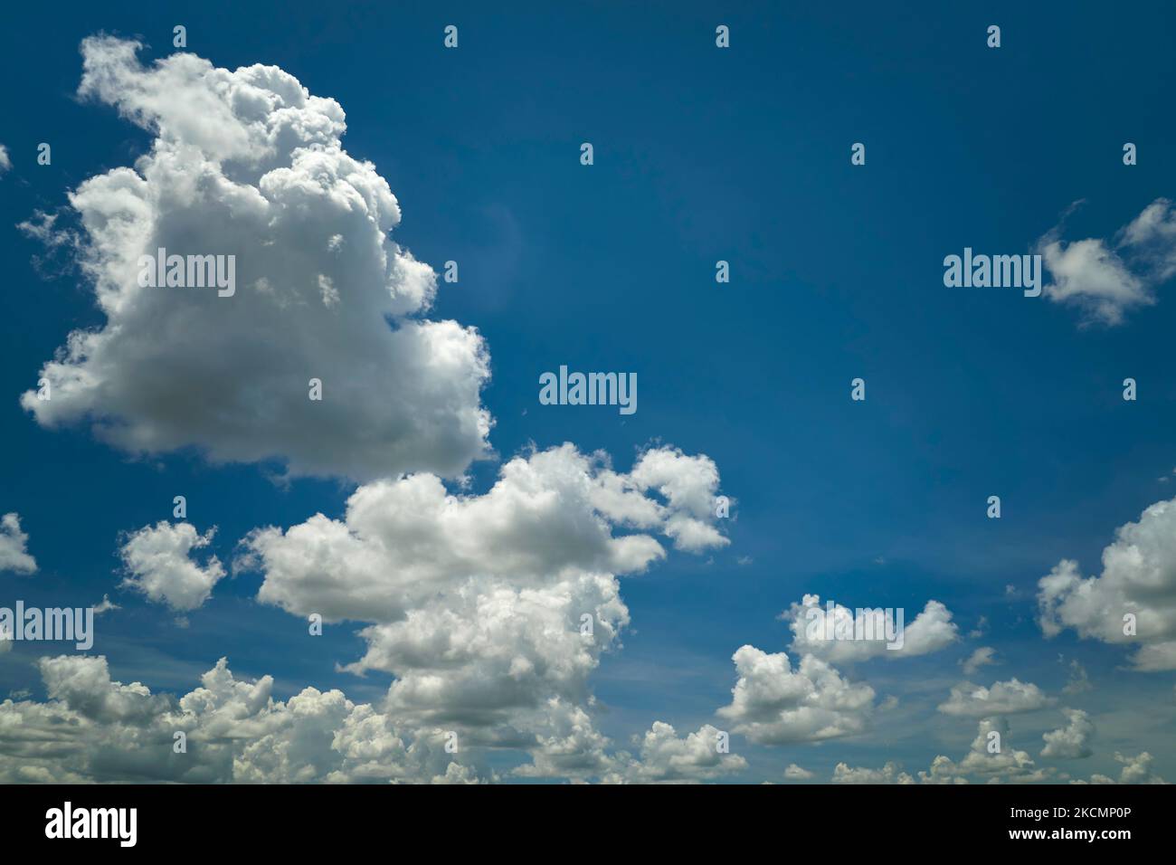 White puffy cumulus clouds on summer blue sky Stock Photo - Alamy