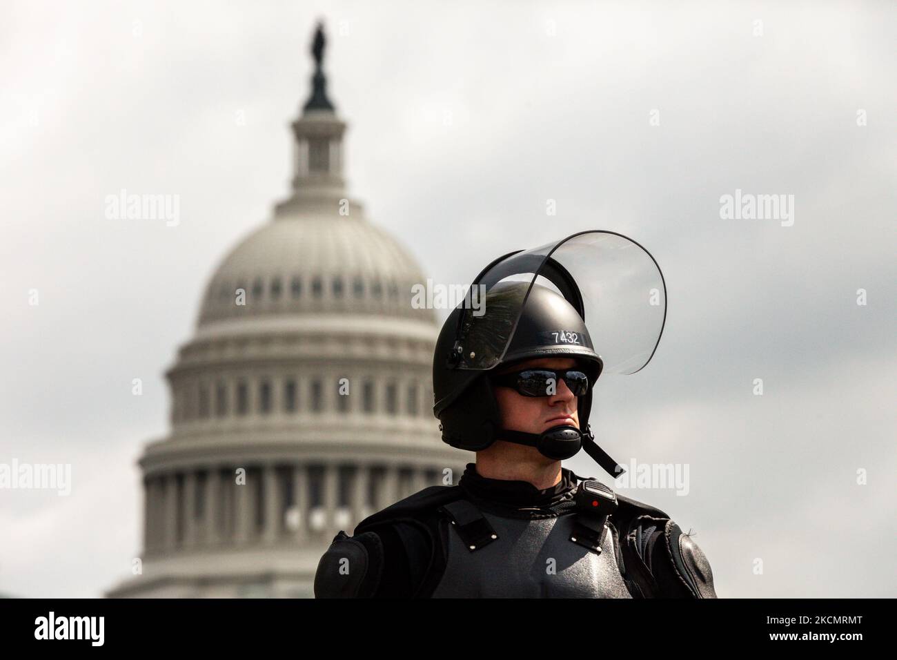 A Capitol Police officer in riot gear stands guard during the Justice ...