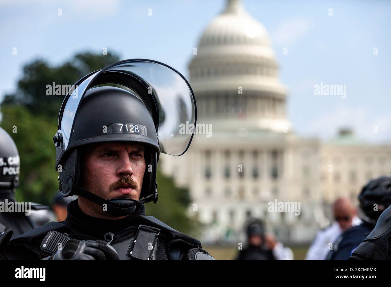 A Capitol Police officer in riot gear stands guard during the Justice ...