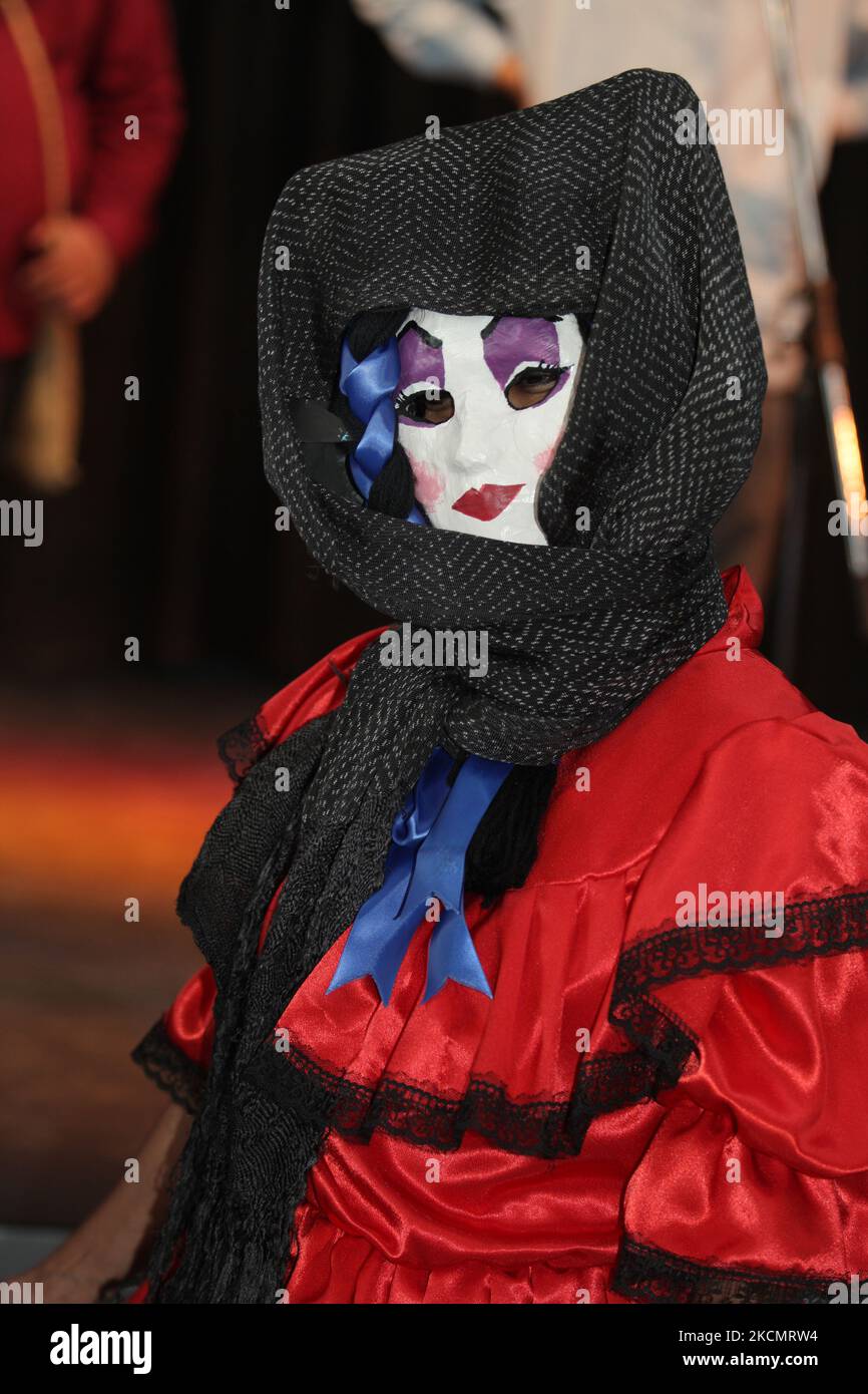 A Masked Mexican dancer performs a traditional dance during the Day of ...