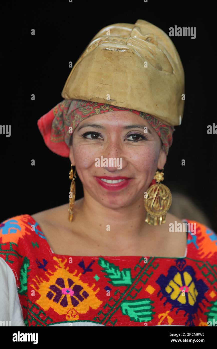 A Masked Mexican dancer performs a traditional dance during the Day of ...
