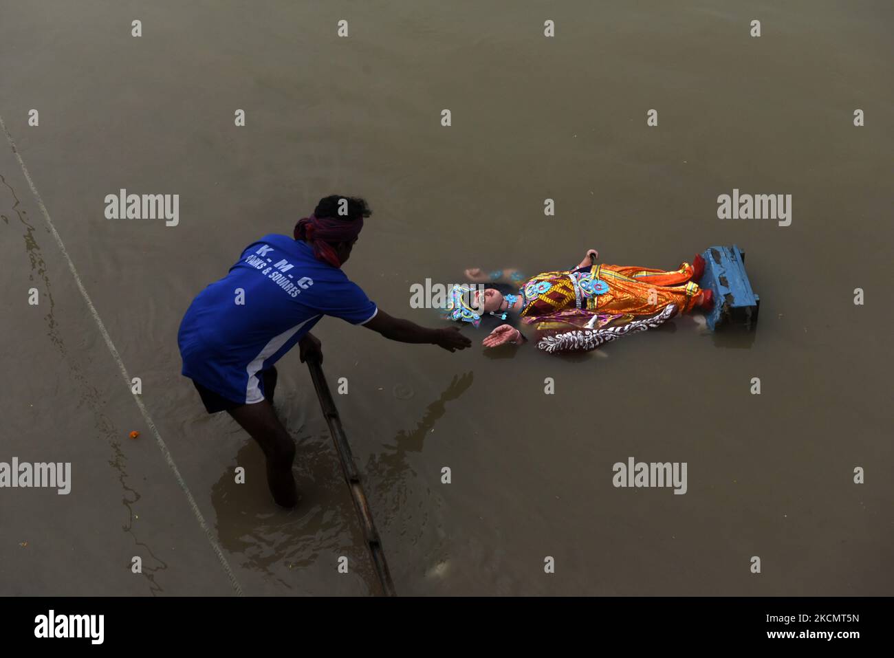 A municipal worker removes Vishwakarma clay made idol from the river ...