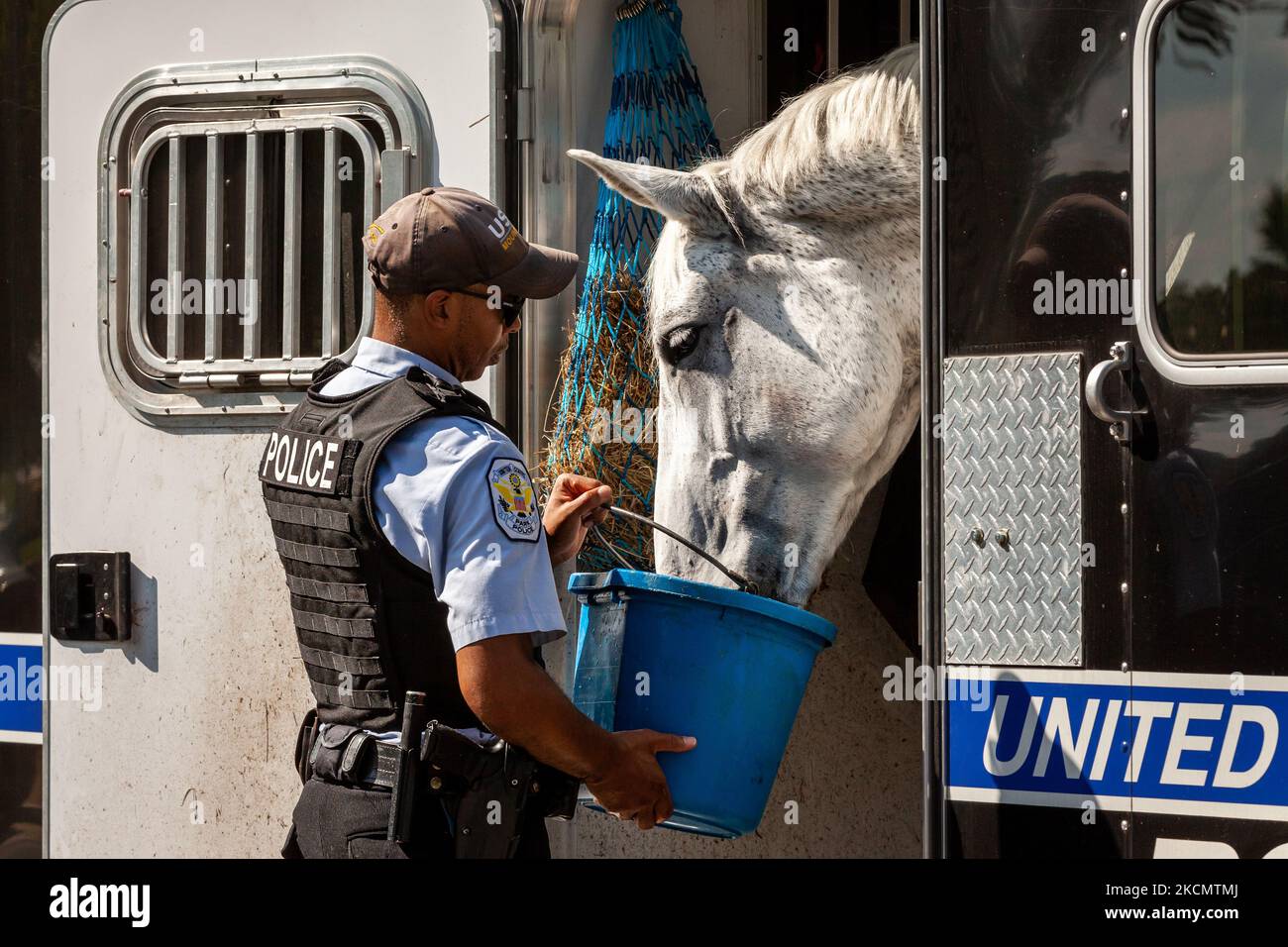 A US Park Police officer gives water to his horse following patrol ...