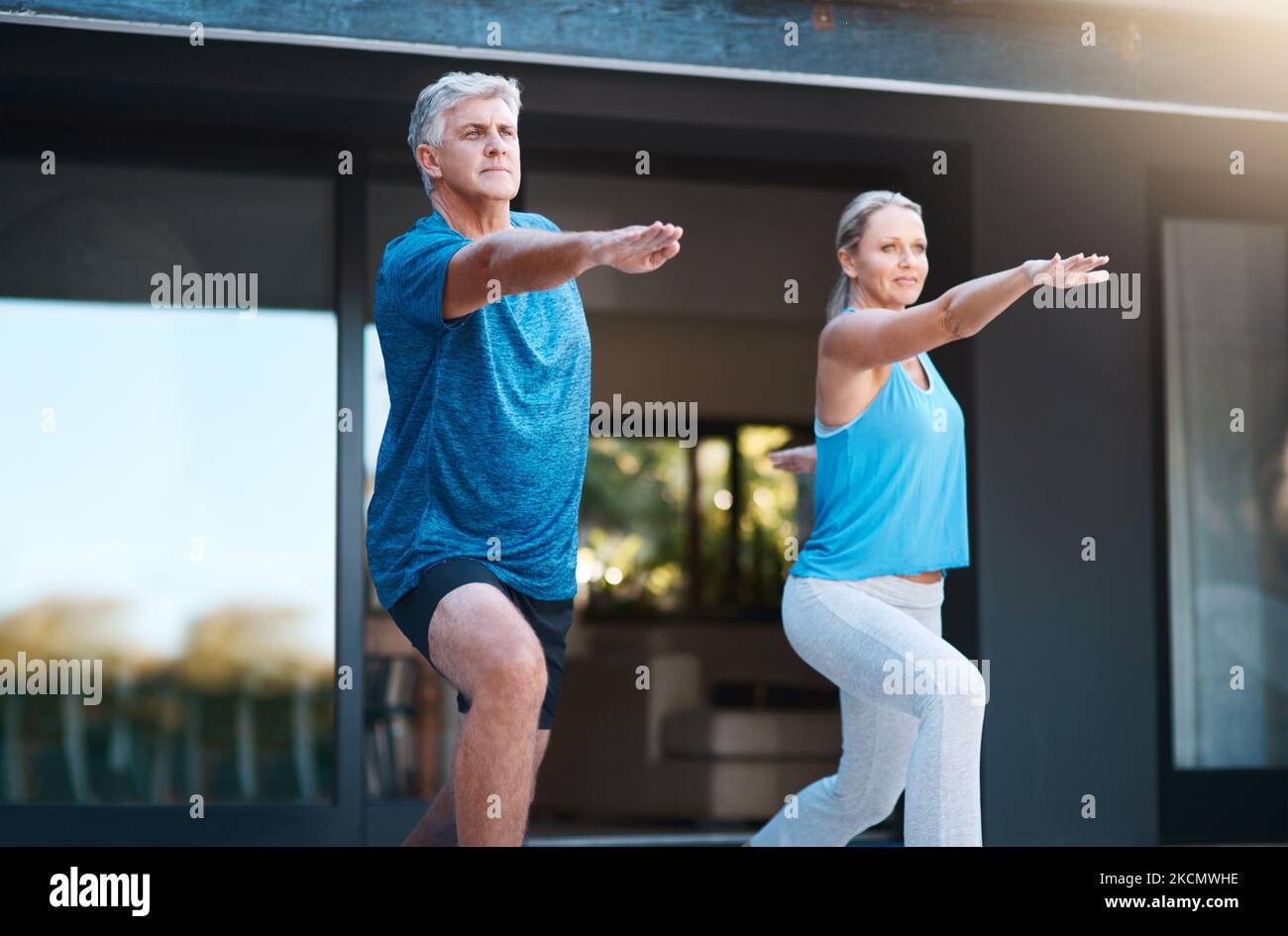 Reaching out for greatness. a mature and happy couple doing yoga ...