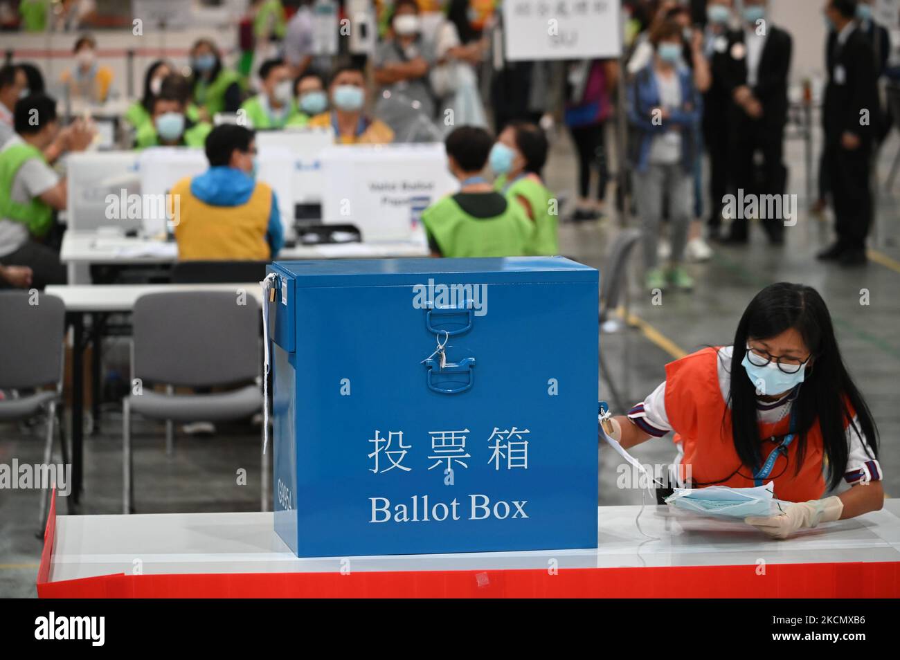A election worker checks the ballot box before counting the votes in ...