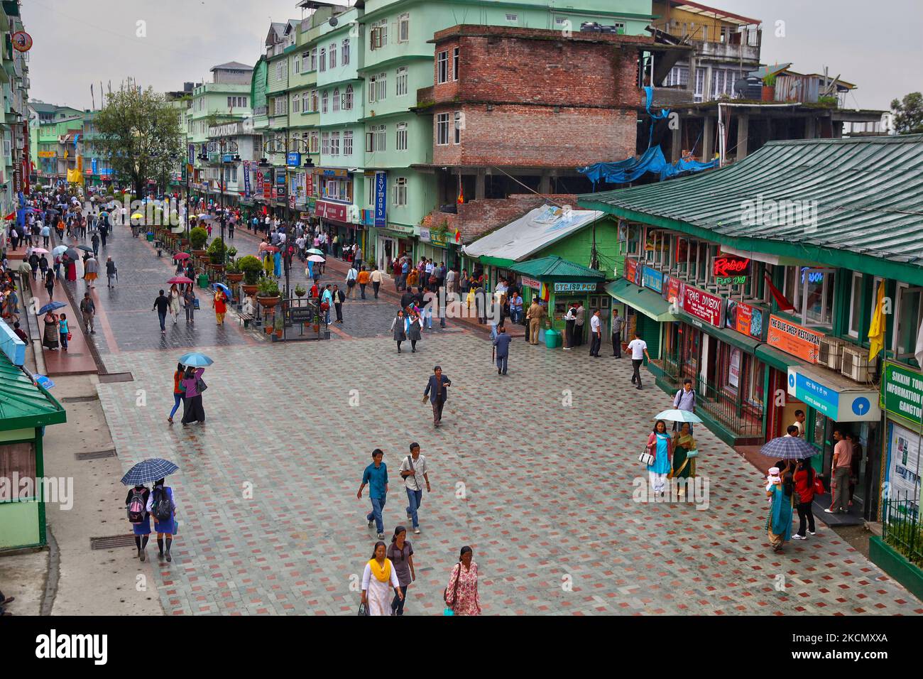 People walk along the M.G. Marg shopping area in Gangtok, Sikkim, India ...
