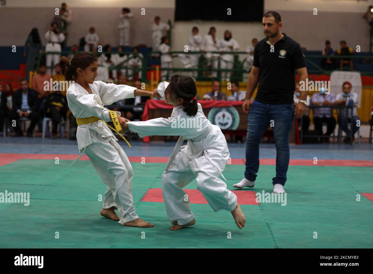 Palestinian players fight during a local Judo Championship, in Gaza ...