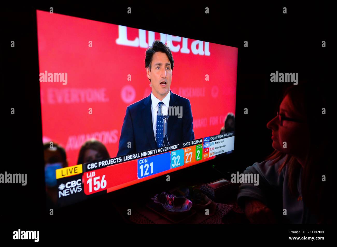 A woman watches Liberal Party of Canada Leader Justin Trudeau speaking ...