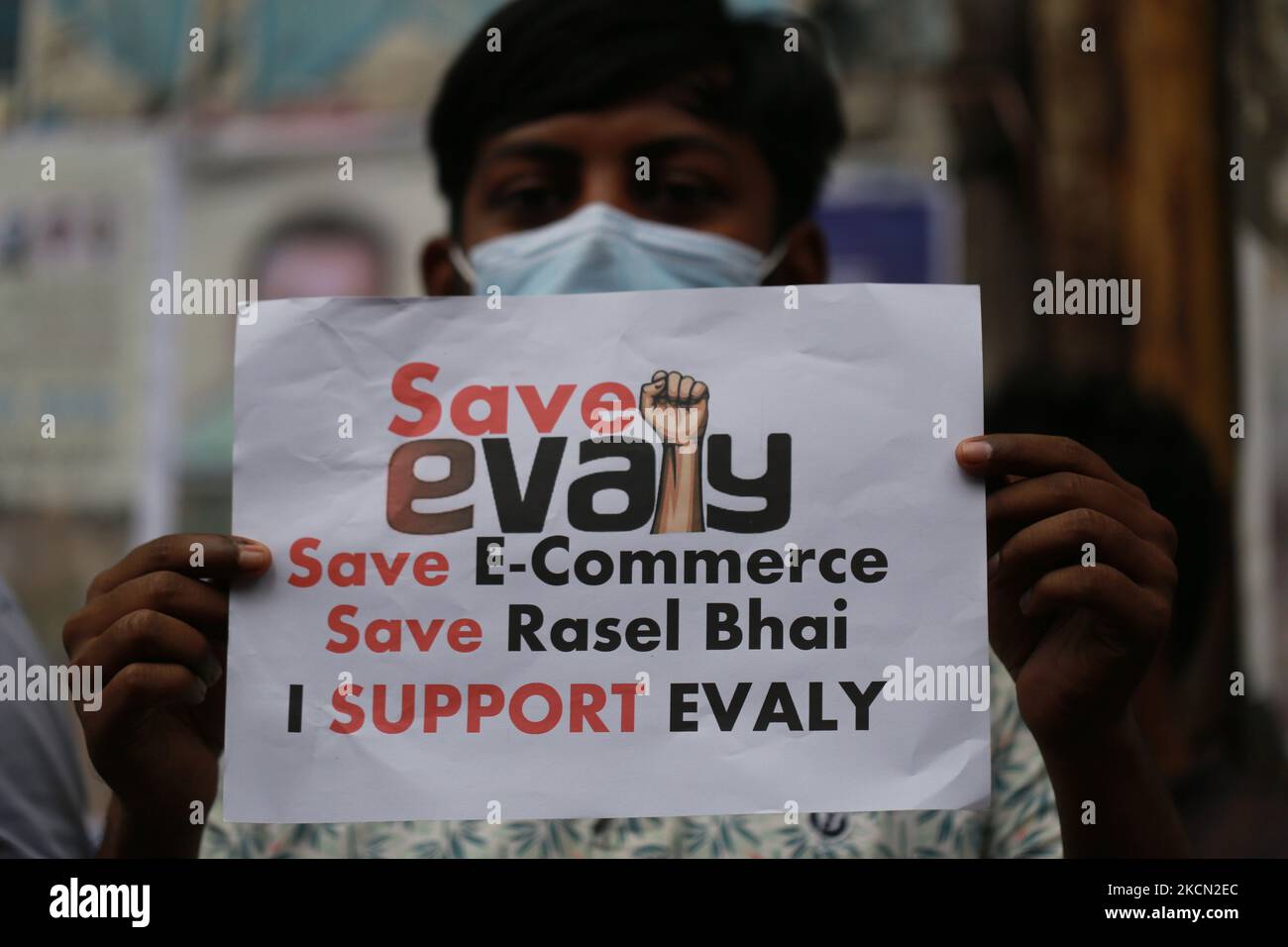 A merchant hold a placard demanding the release of the e-commerce ...