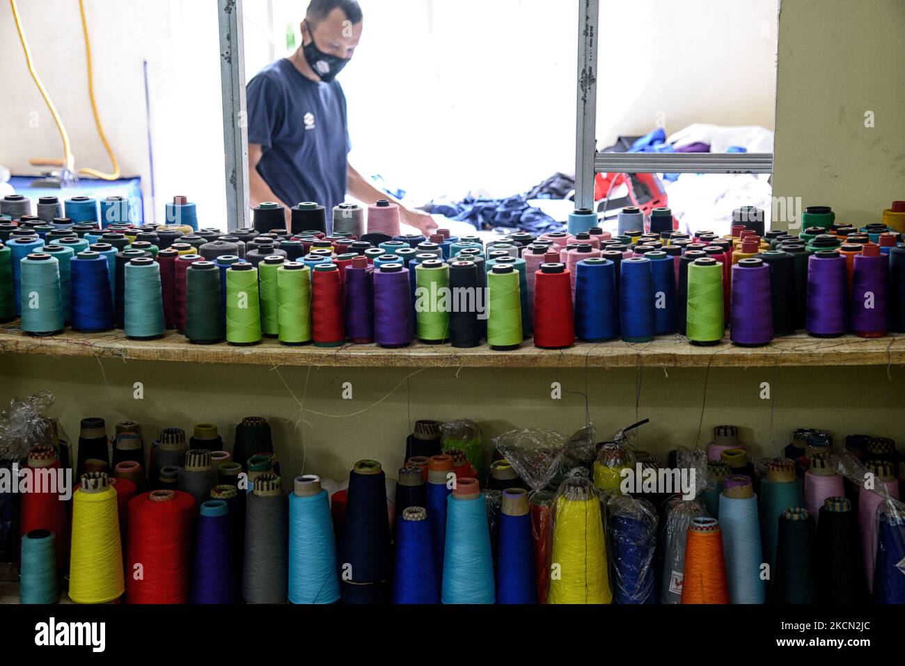 An employee works at the production line of Indonesia sport jerseys ...