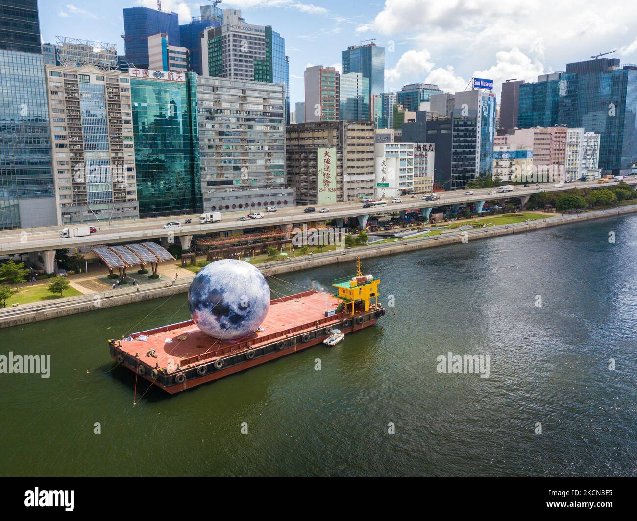 A 15-meter diameter ''moon'' is exhibited on a barge near Kwun Tong ...