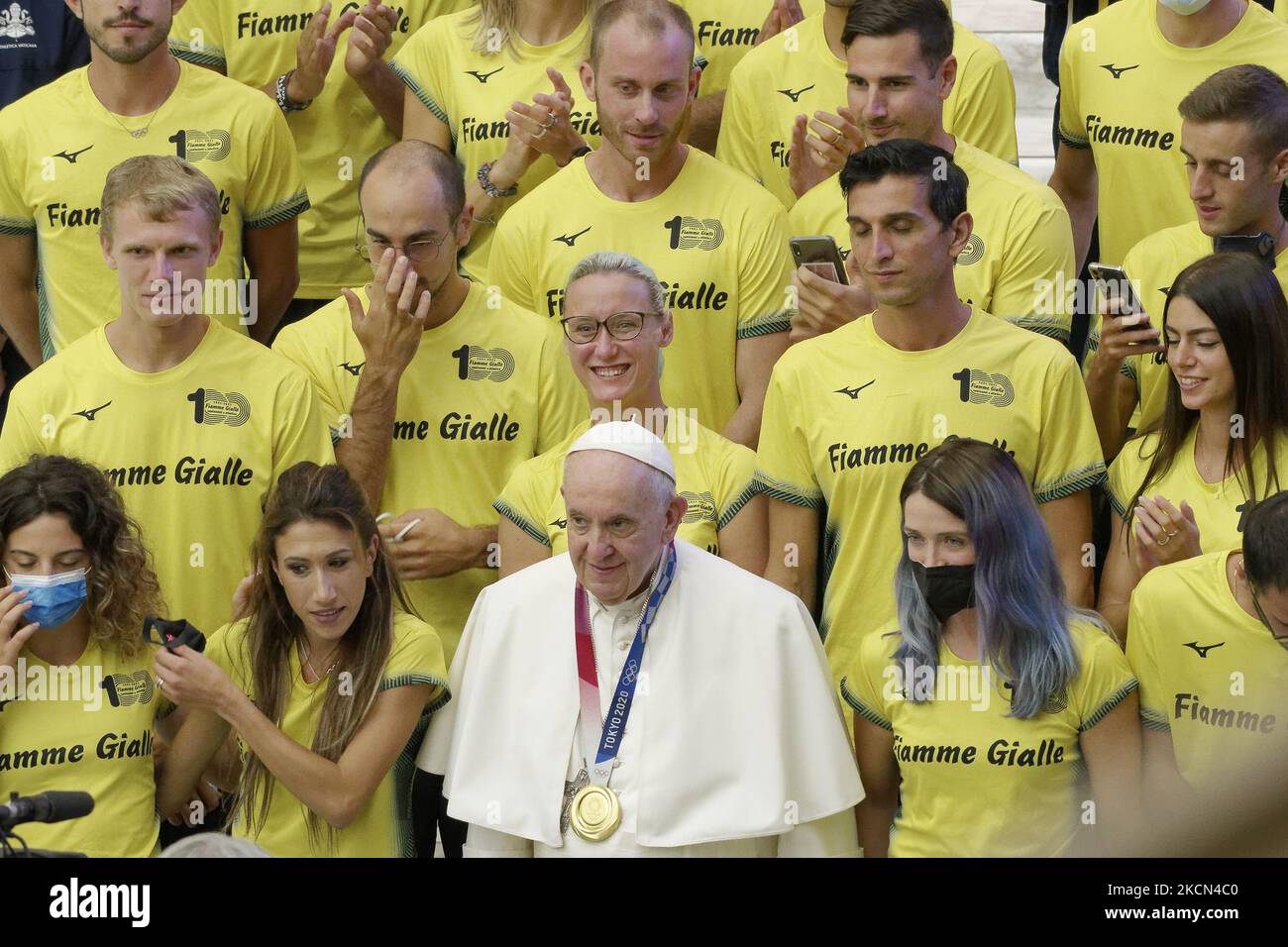 Pope Francis poses for a photo wearing an Olympic gold medal as he ...