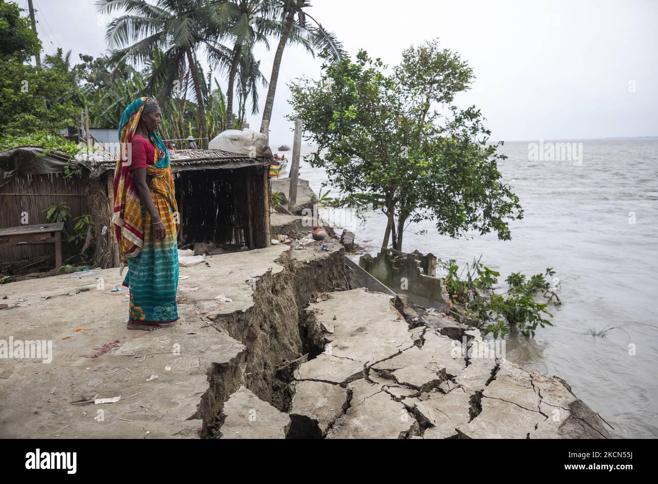 A women looks at The Padma River where she has lost her house by river ...