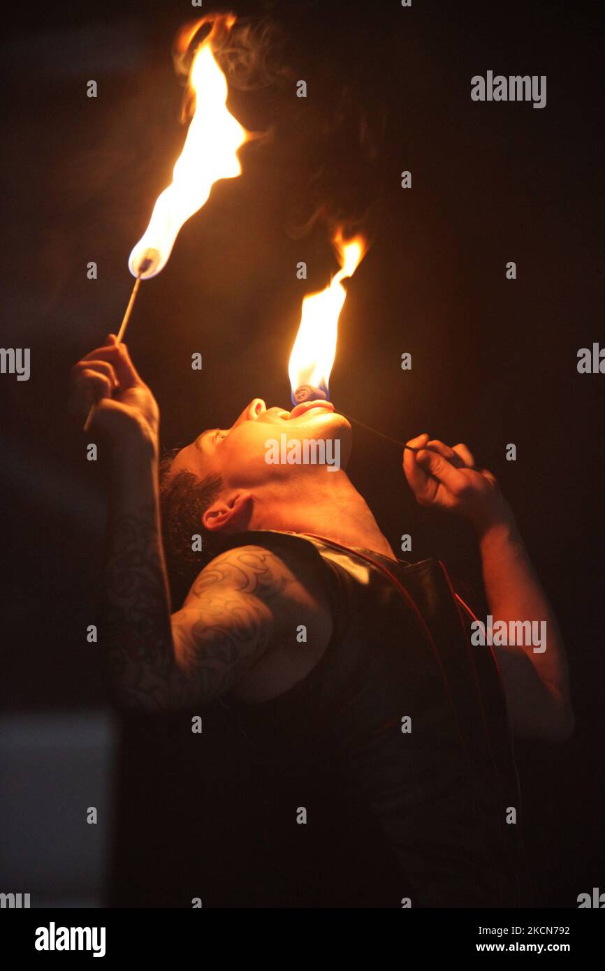 A fire eater with the Zero Gravity Circus performs for the crowd in ...