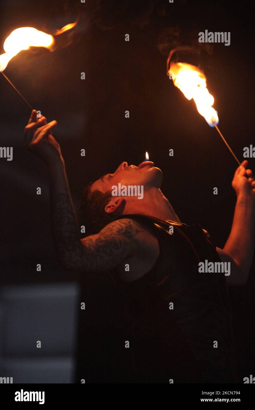 A fire eater with the Zero Gravity Circus performs for the crowd in ...