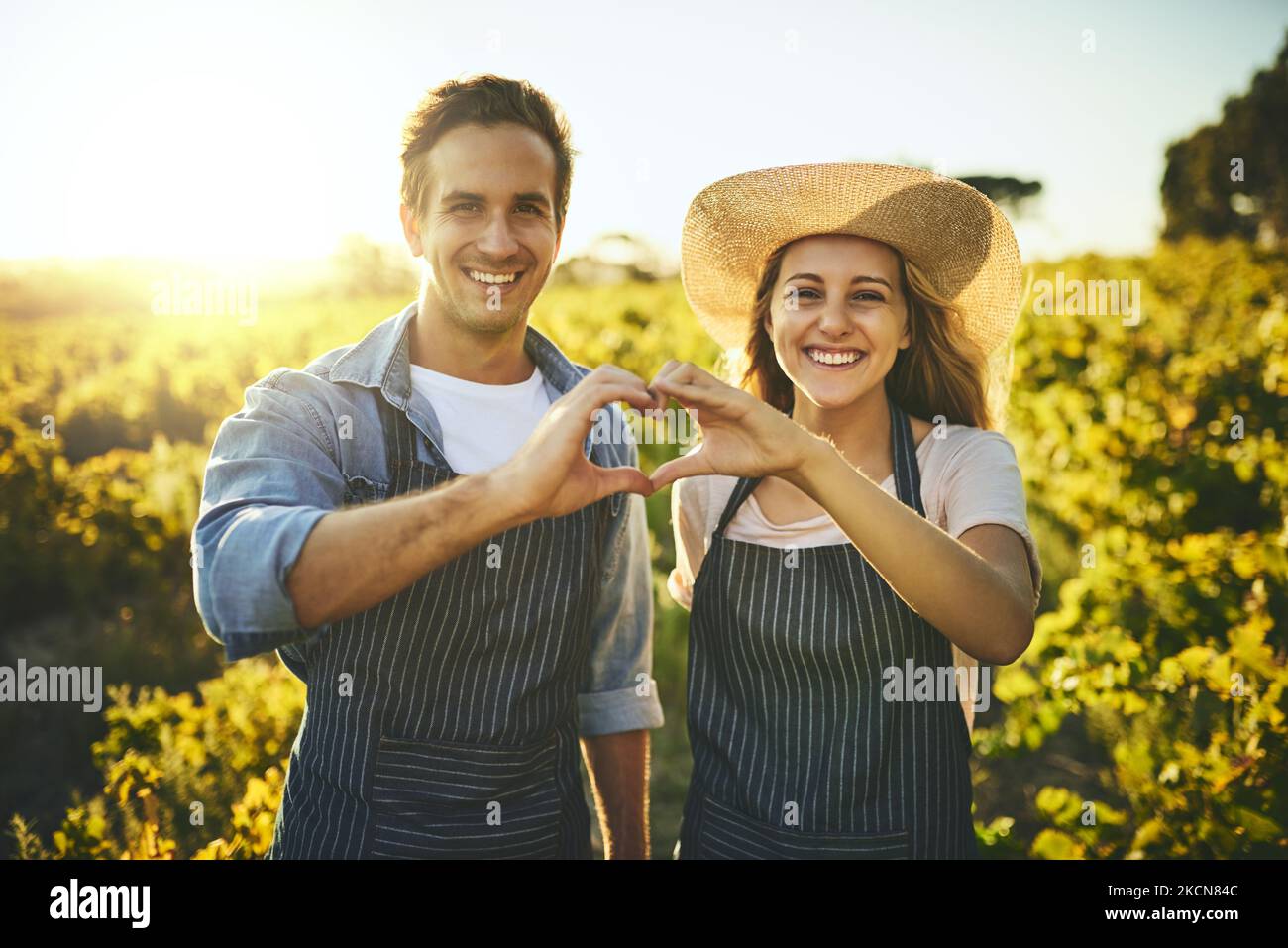 Our love grows each day like our crops. a young couple holding up their ...