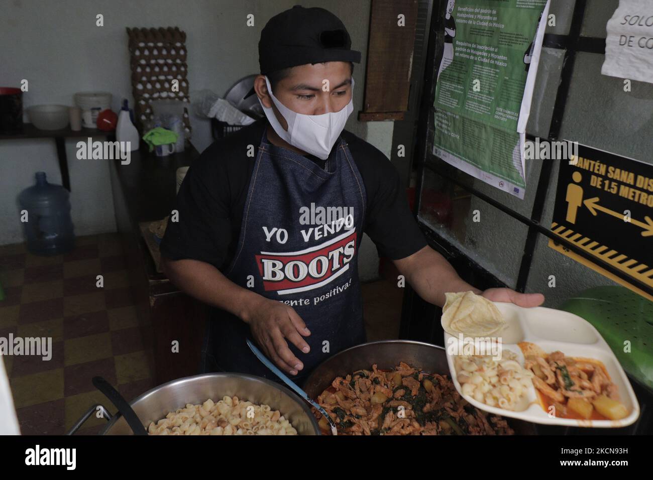 A Central American migrant works as a cook at the Casa Tochán (Our ...