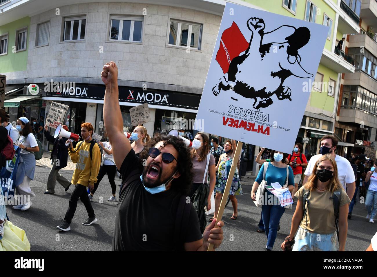An activist holding a protest sign shouts slogans against pollution ...