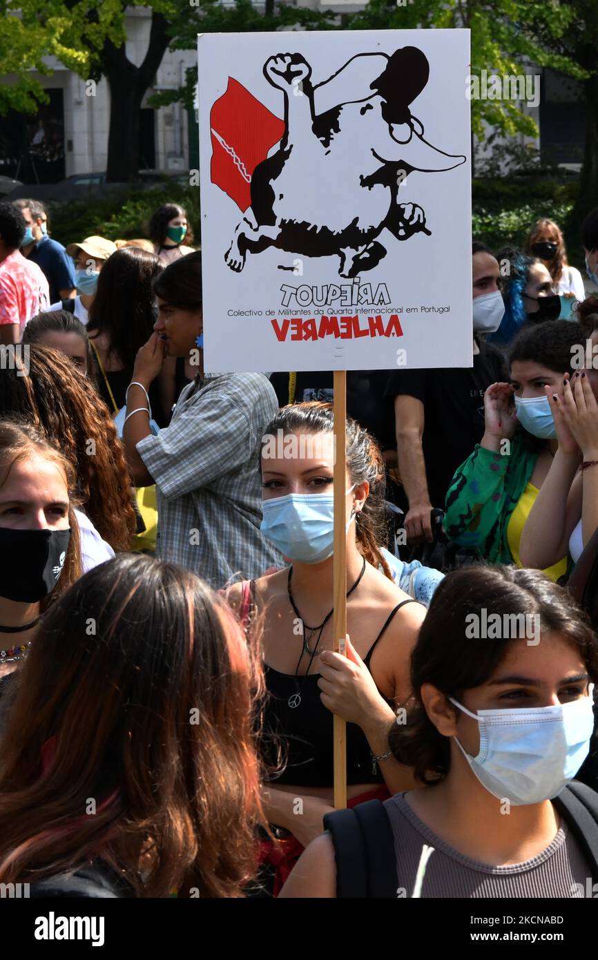 A demonstrator holds a protest sign during the march for the ...