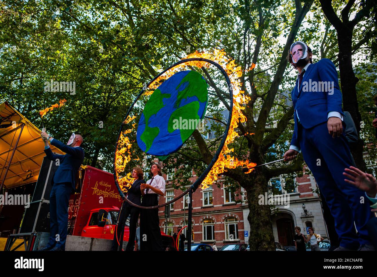 A group of activists is setting on fire a circle that represents the ...