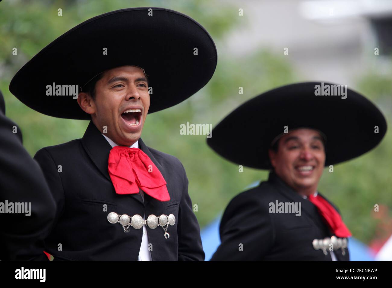 Mexican dancers and singers wearing sombreros perform a cultural dance ...