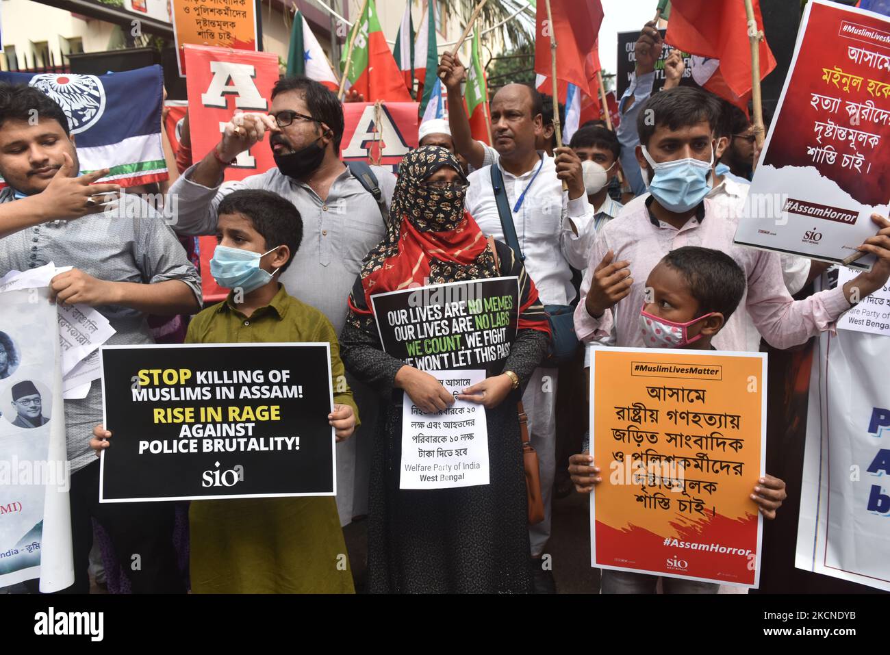 Protesters are seen holding placards as massive protest erupted in ...