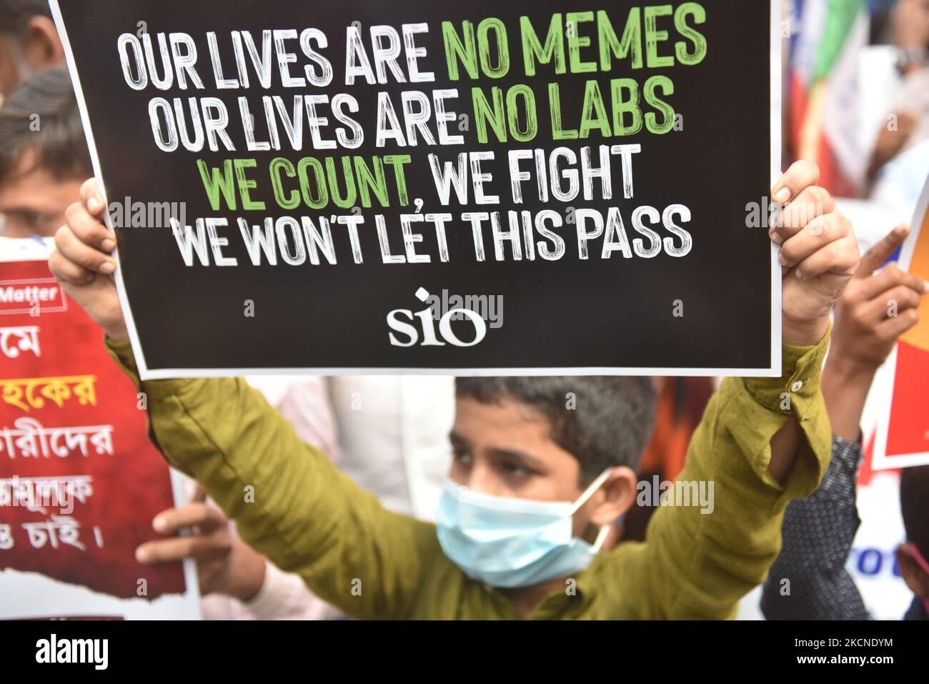 A boy is seen seen holding placard during a as massive protest erupted ...