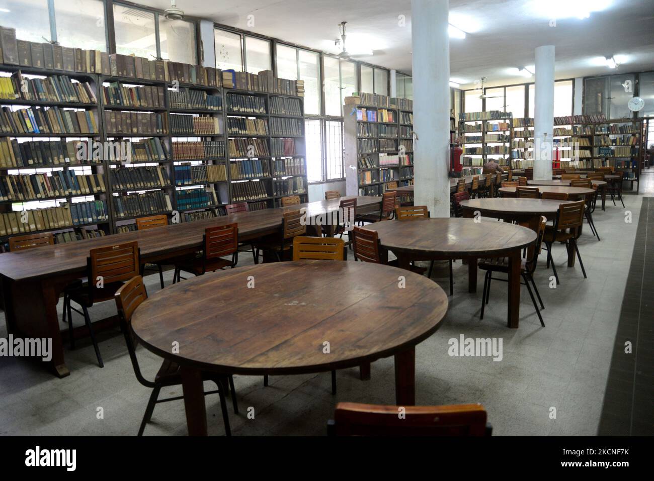 Books are seen on shelves in the central library of Dhaka University ...