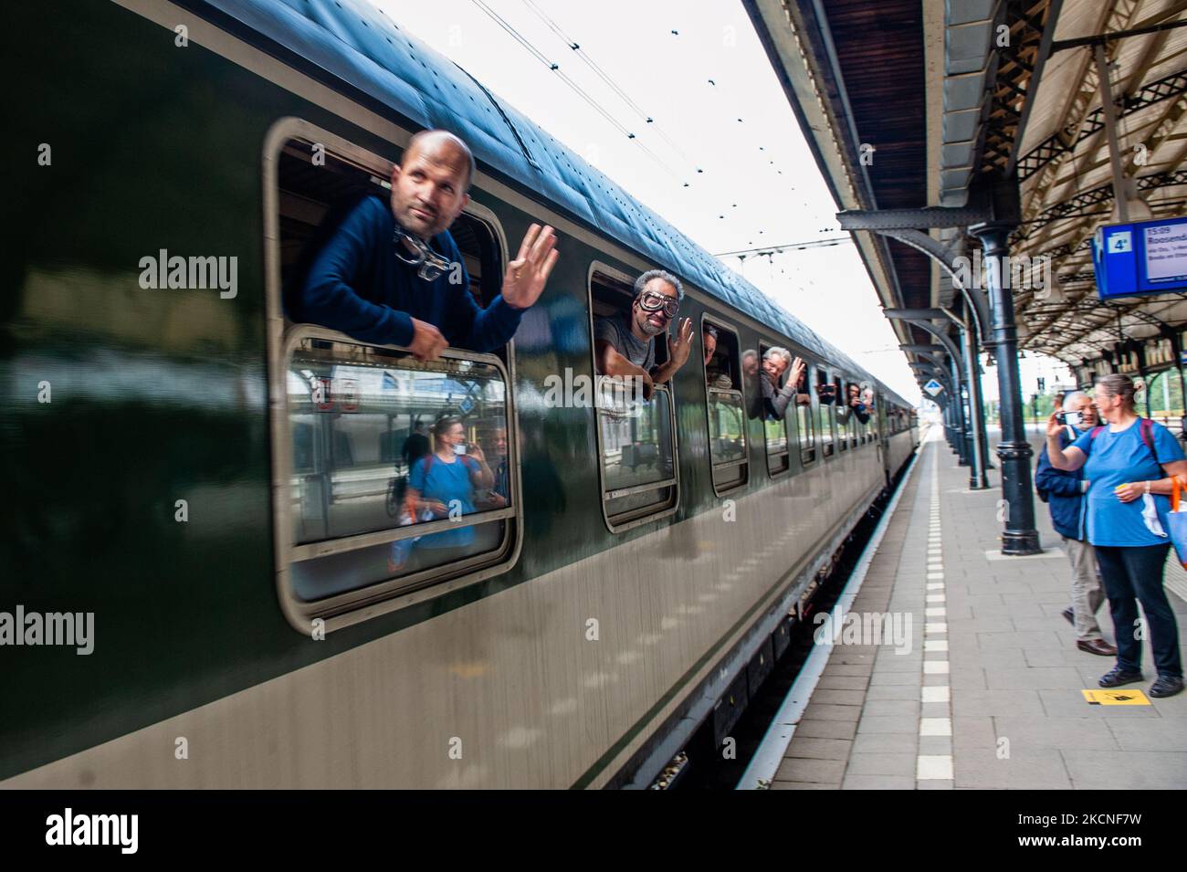 Passengers are looking through the windows of the 40's German ...