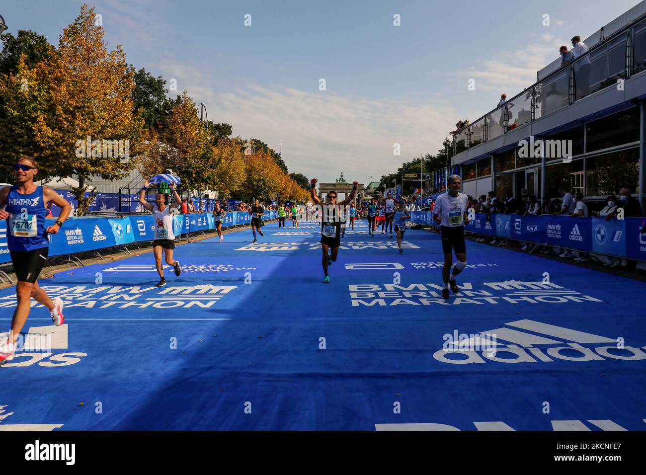 Participants run in front of Brandenburg gate as thousands of people ...